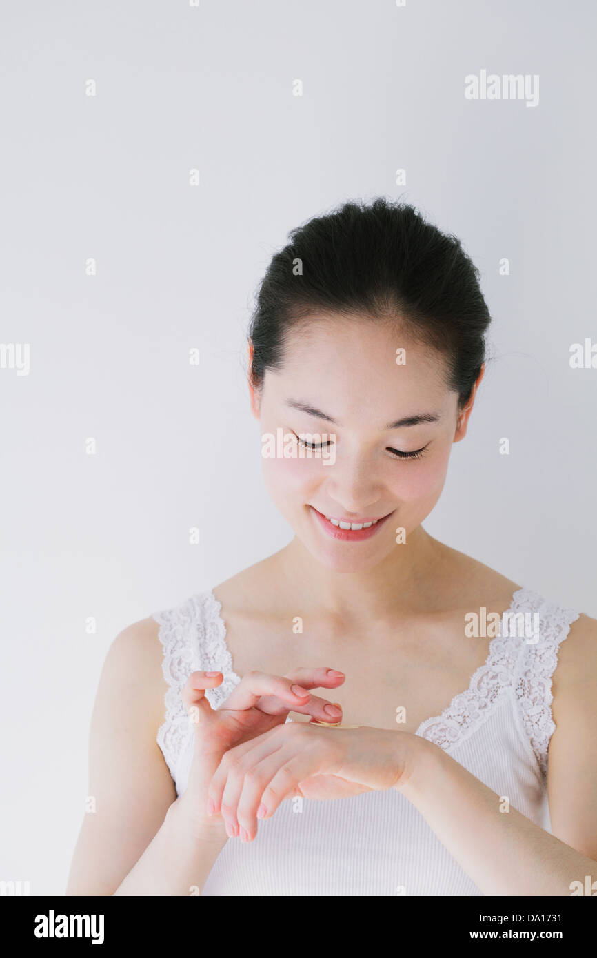 Young woman putting foundation cream Stock Photo - Alamy