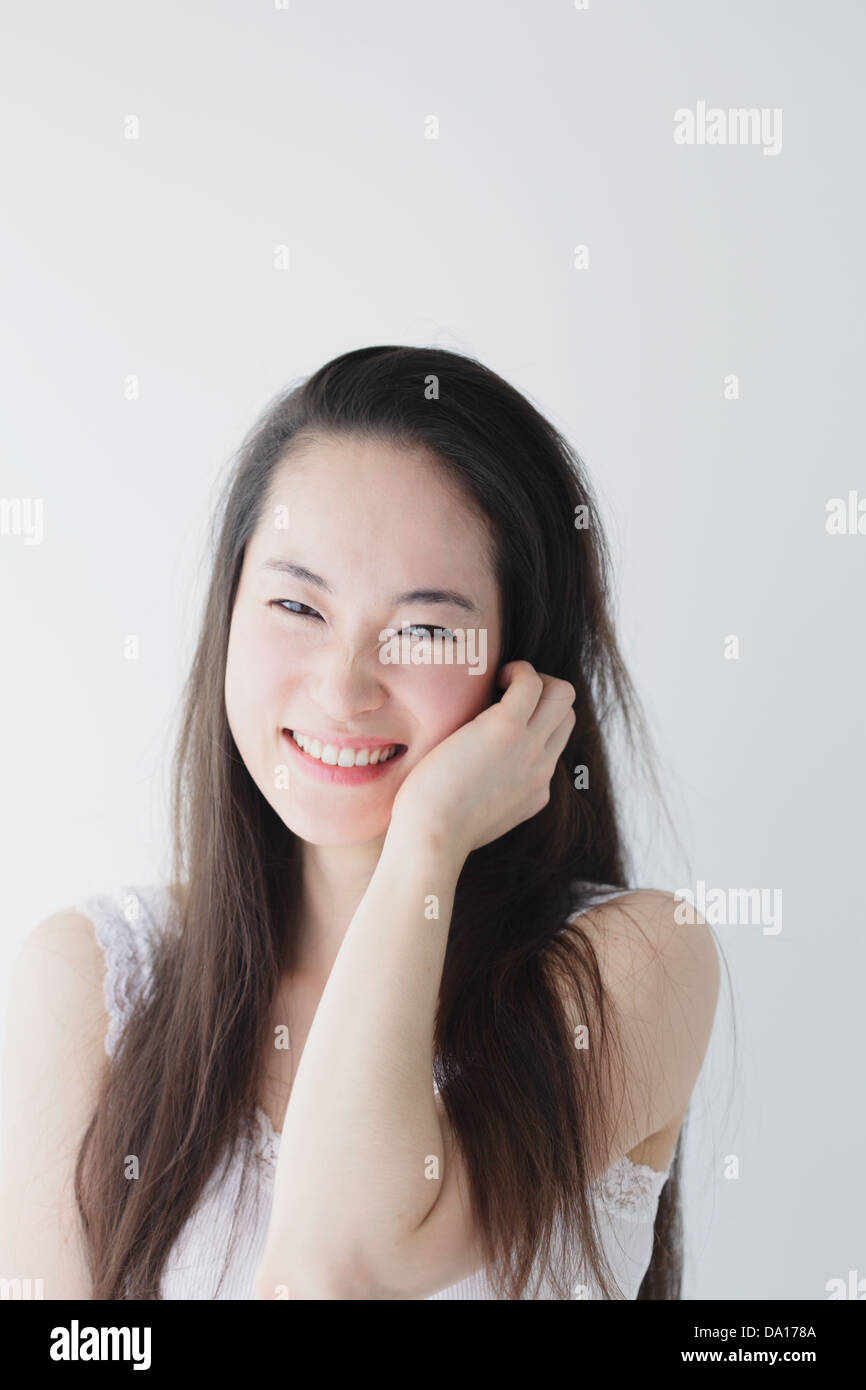 Young woman with long hair smiling Stock Photo - Alamy