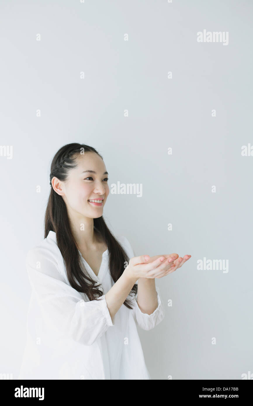Young woman with long hair raising arms Stock Photo - Alamy