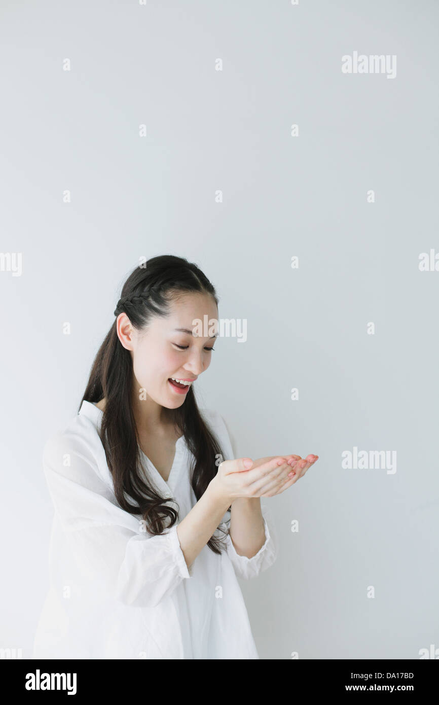 Young woman with long hair raising arms Stock Photo - Alamy
