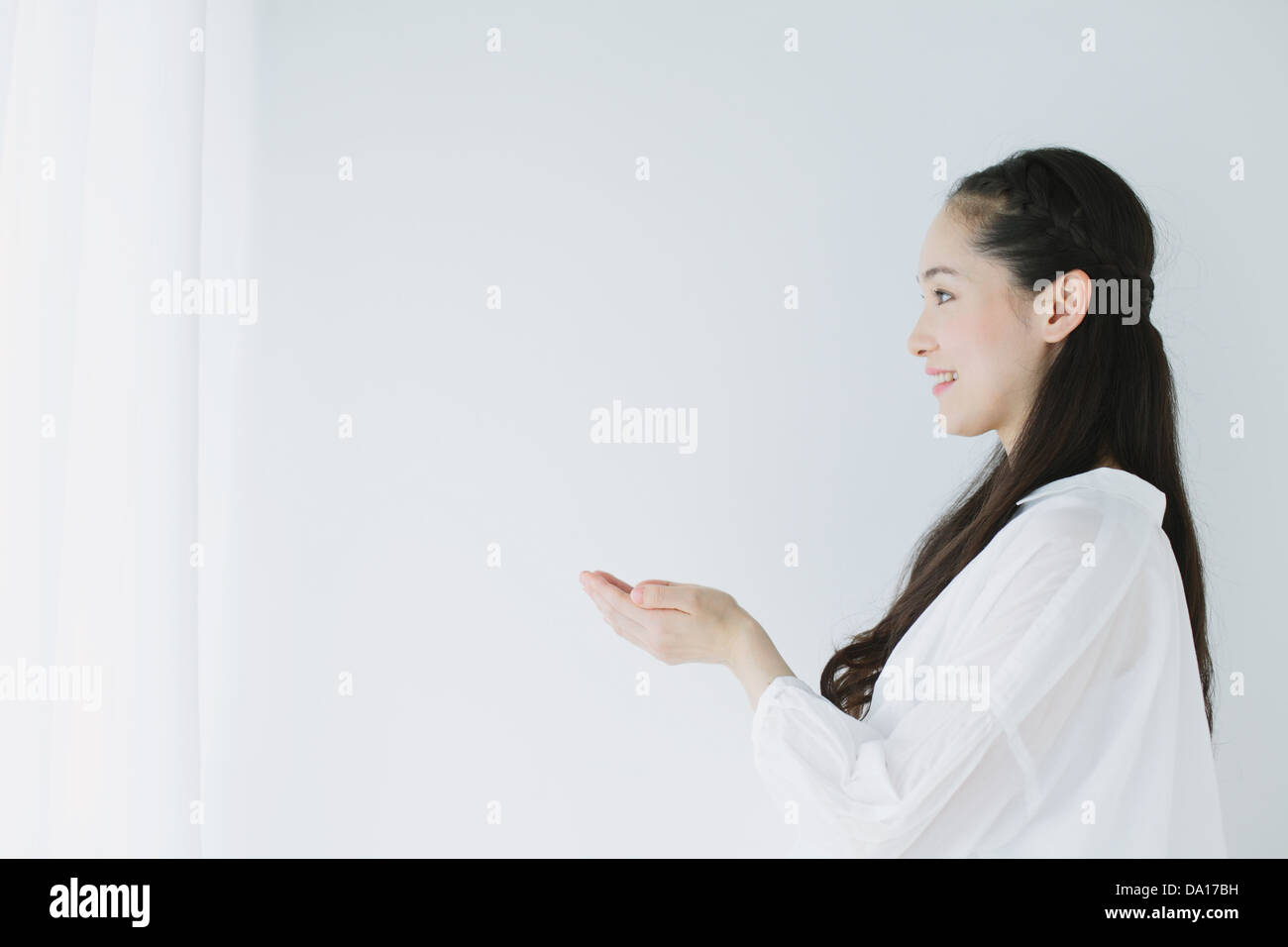 Young woman with long hair raising arms Stock Photo - Alamy