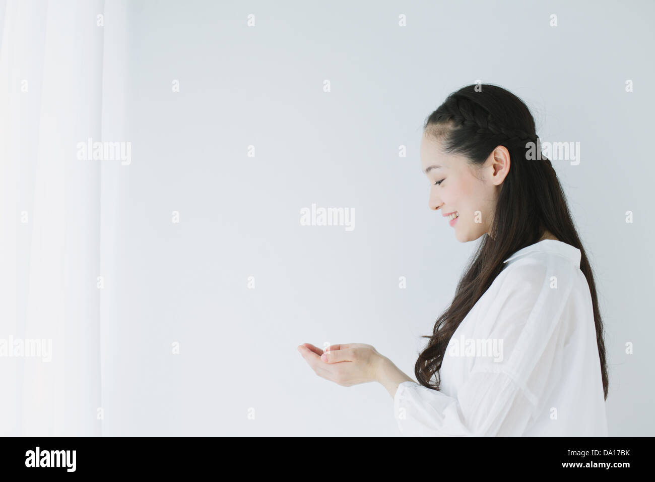 Young woman with long hair raising arms Stock Photo - Alamy