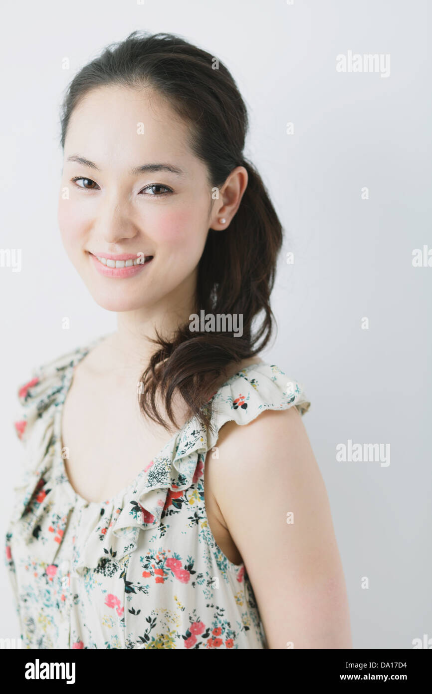 Young woman wearing one piece smiling Stock Photo - Alamy
