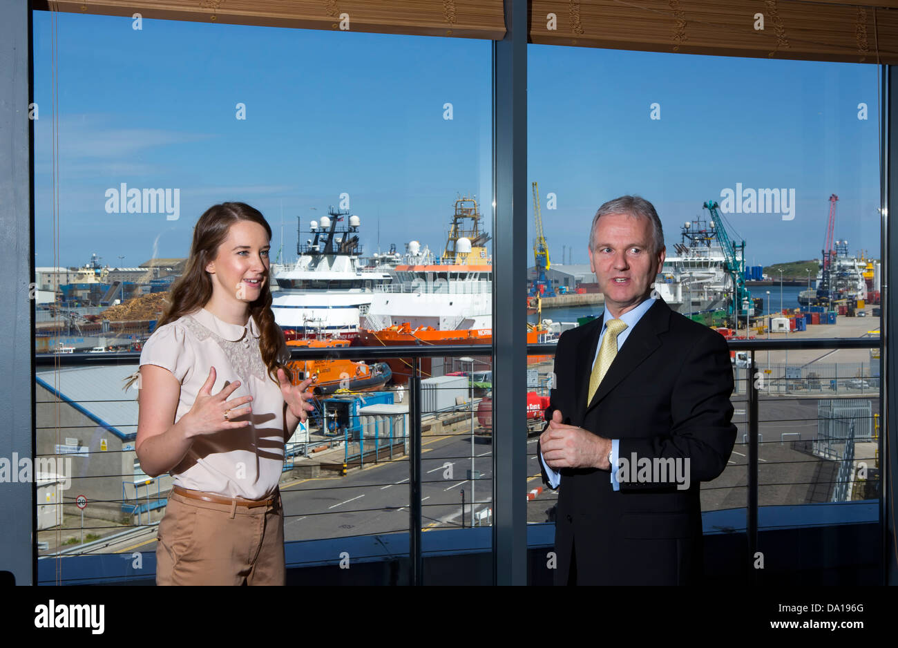 Suited Business people at the overlooking the harbour in Aberdeen city ...