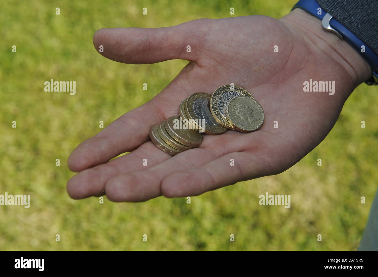 Coins in palm of hand hi-res stock photography and images - Alamy