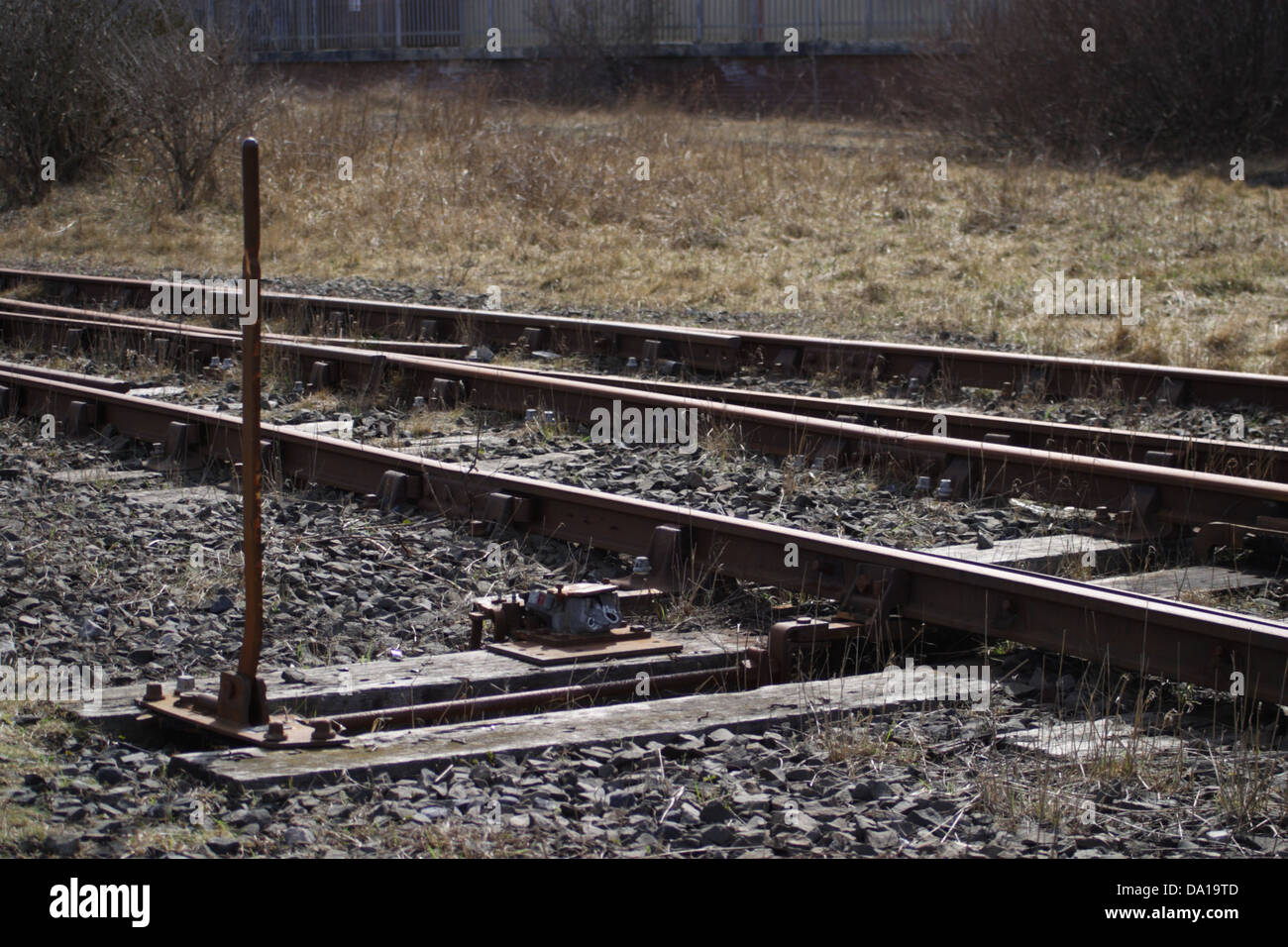 Railway point and lever at the side of disused abandoned railway tracks ...