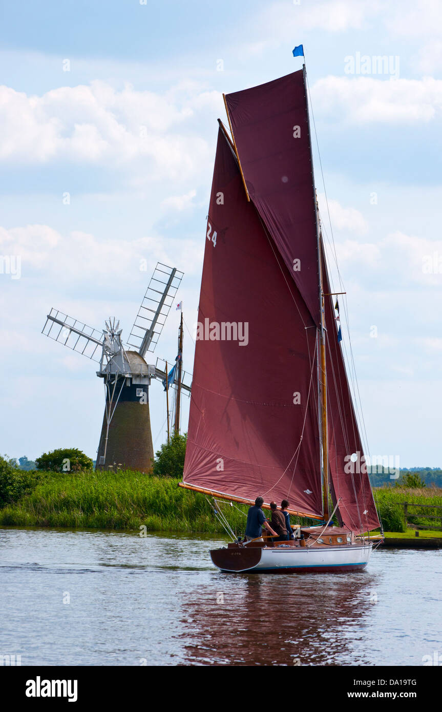 Traditional Norfolk broads sailing boat Yacht passing windmill Stock ...