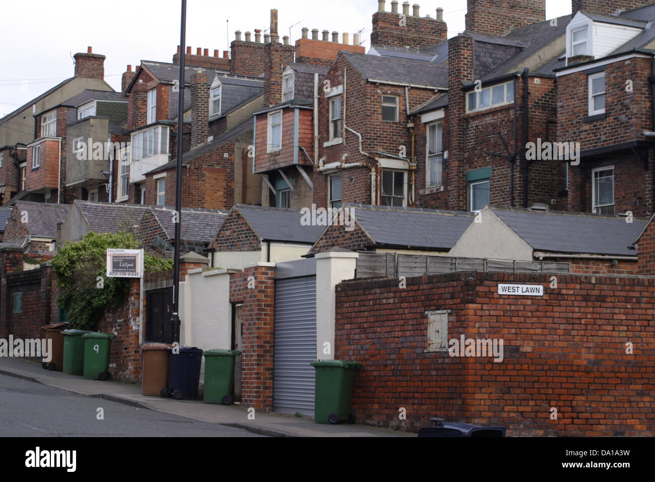 A back lane in sunderland,england. Rear of a street of multi-storey ...