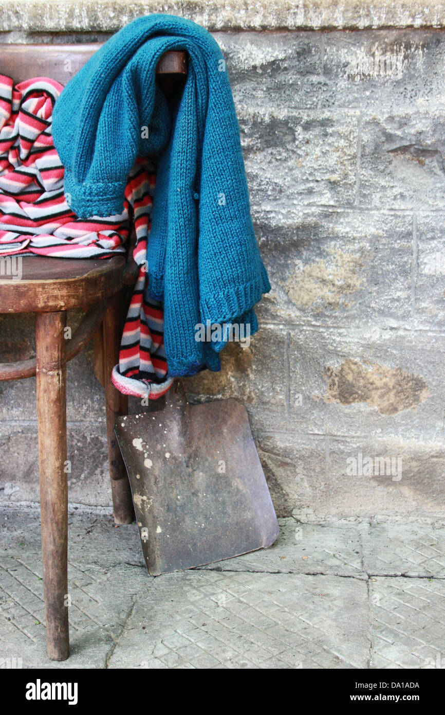 Picture of old clothes abandoned on dirty wooden chair Stock Photo - Alamy