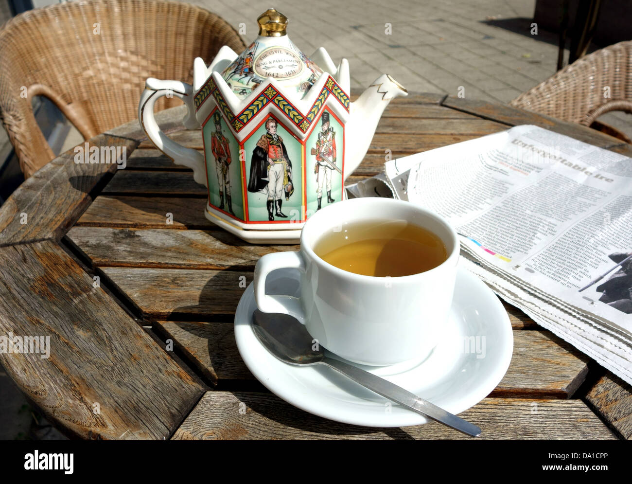 Cup of peppermint tea and teapot on cafe table, London Stock Photo - Alamy