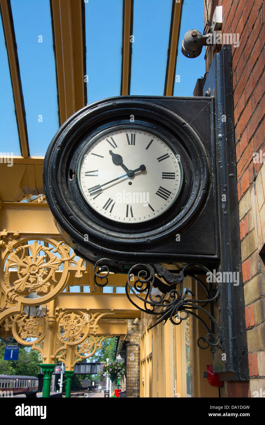 Antique style railway station clock wall mounted with platform in the ...
