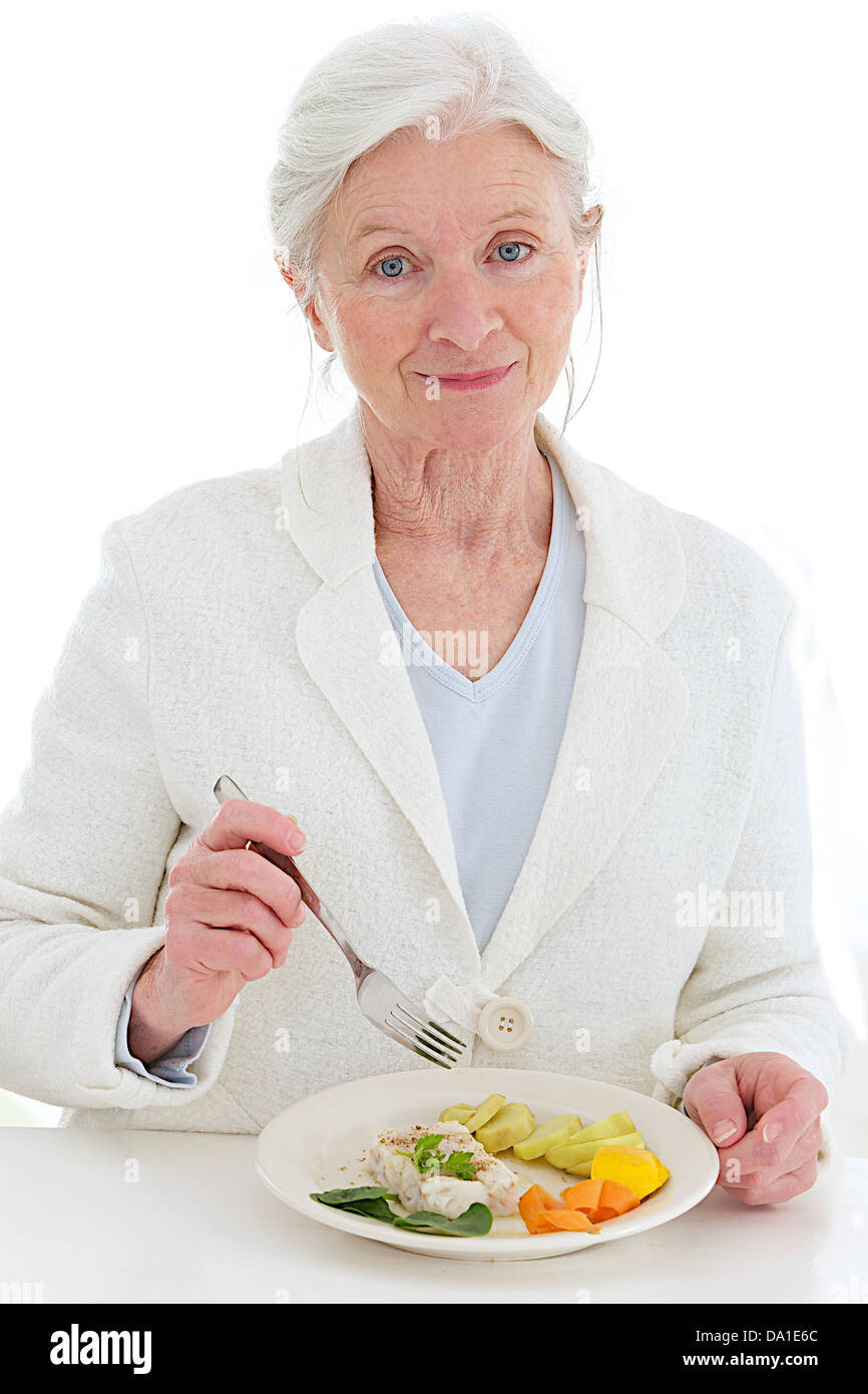 Senior woman eating fish hi-res stock photography and images - Alamy