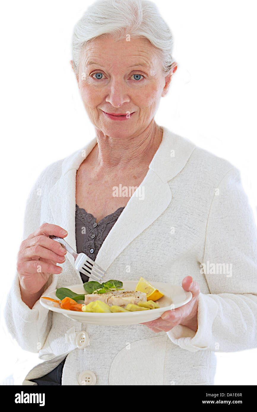 Senior woman eating fish hi-res stock photography and images - Alamy