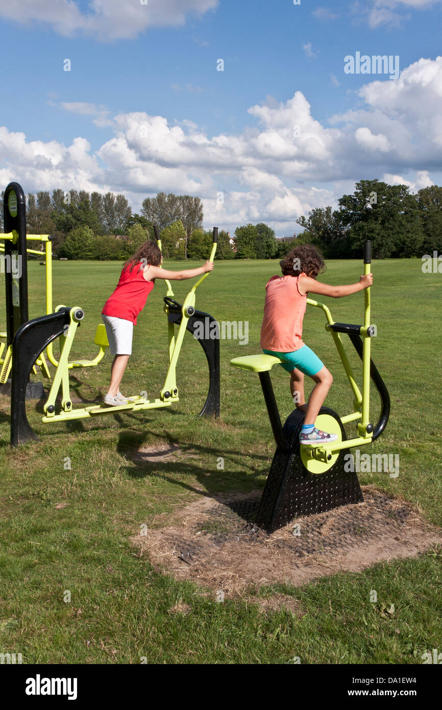 Children exercising at an outdoor gymasium in a public park in southern ...