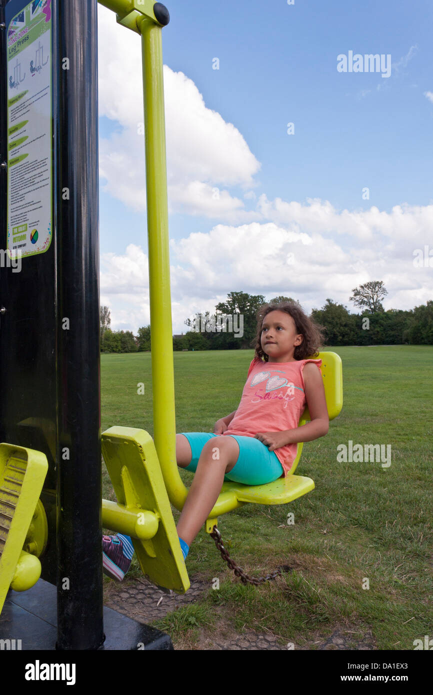 Children exercising at an outdoor gymnasium in a public park in ...