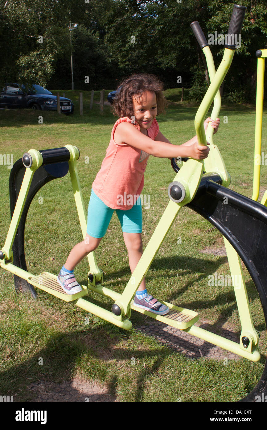 Children exercising at an outdoor gymnasium in a public park in ...