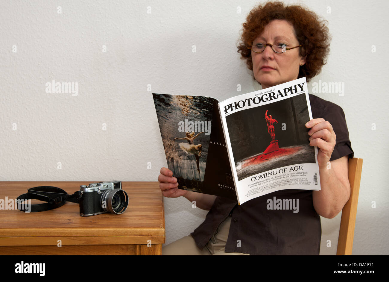 Freelance photographer reading a copy of the British Journal of ...