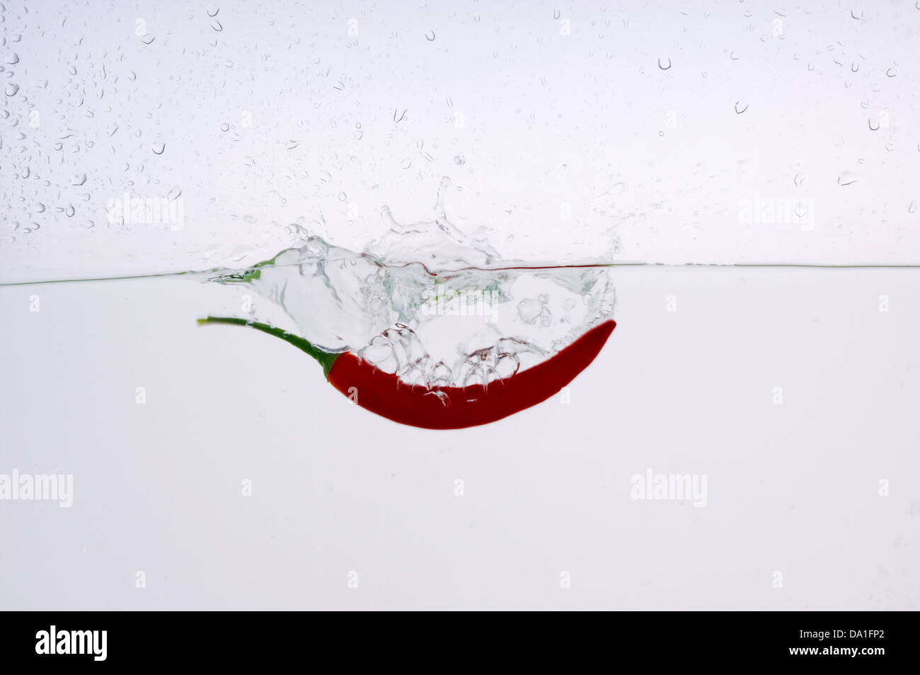 Chili pepper splashed into water Stock Photo - Alamy