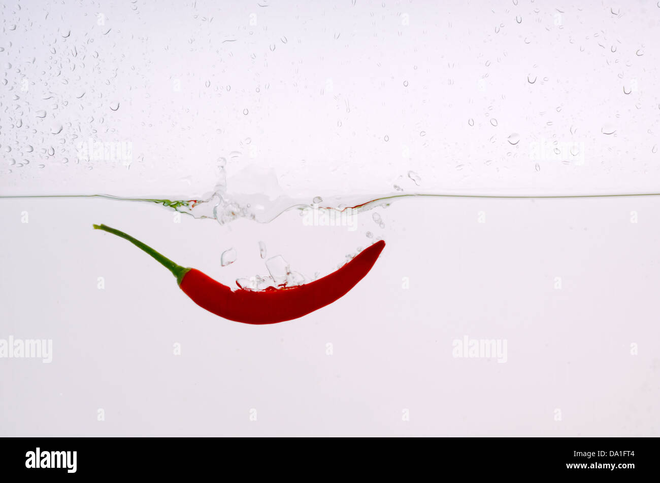 Chilli pepper splashed into water Stock Photo - Alamy
