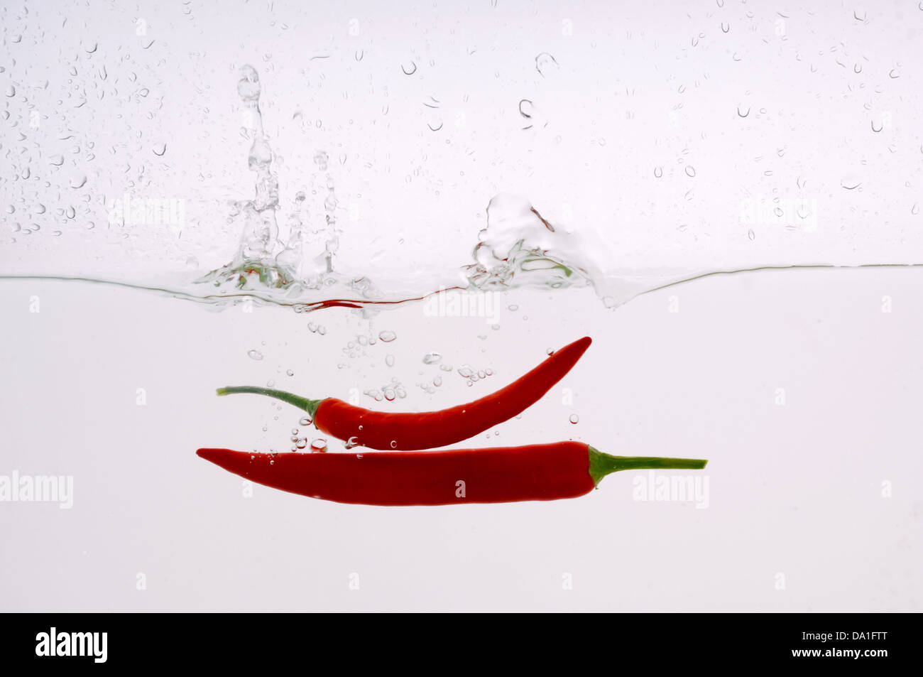 Chilli pepper splashed into water Stock Photo - Alamy