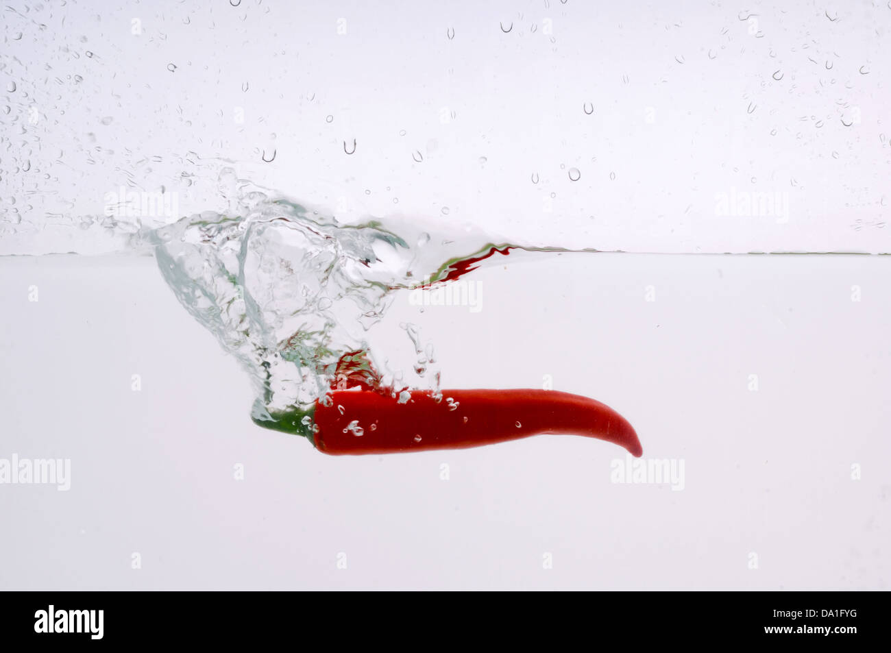 Chilli pepper splashed into water Stock Photo - Alamy