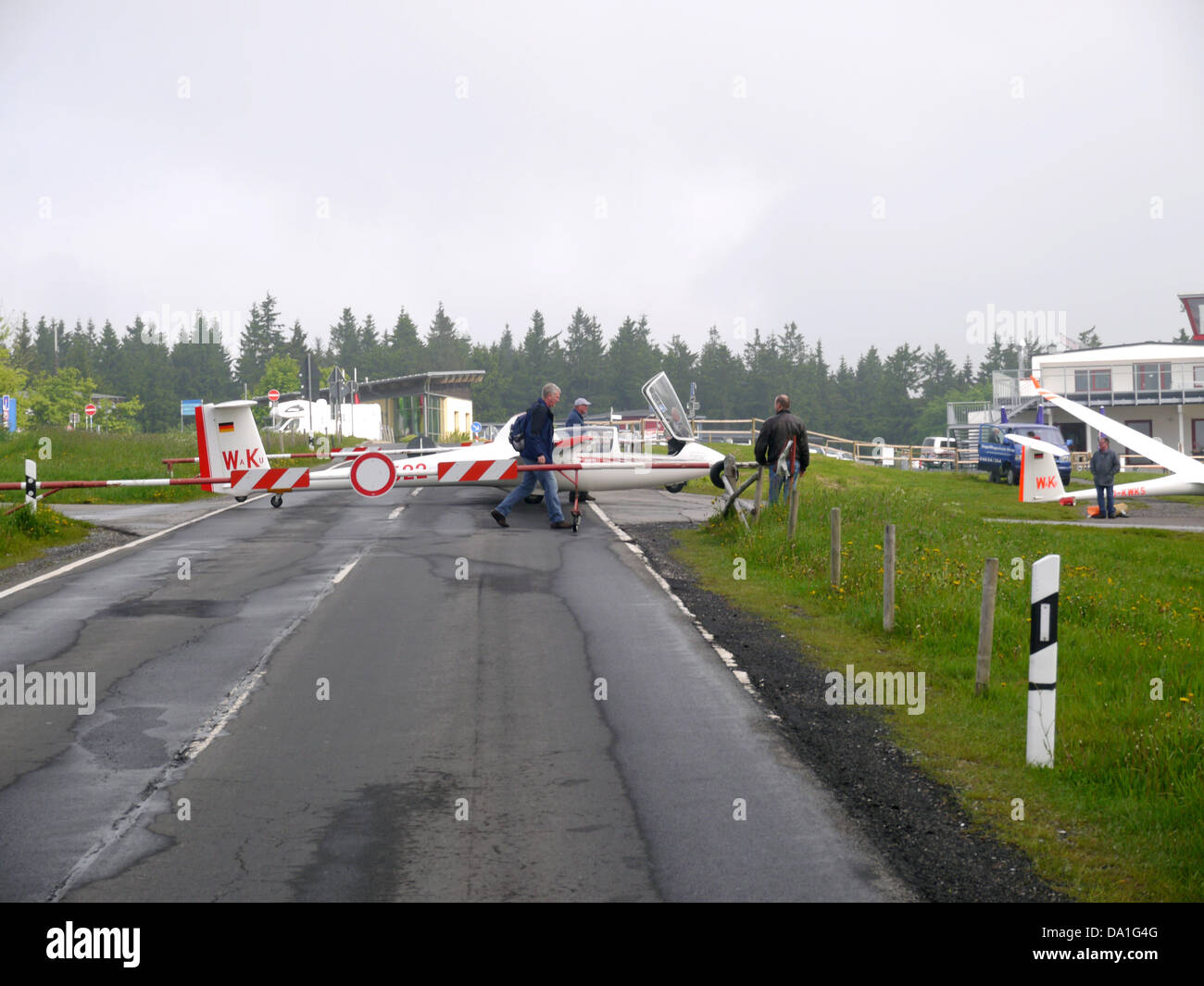 A glider stands on the runway on mount Wasserkuppe in Gersfeld, Germany ...