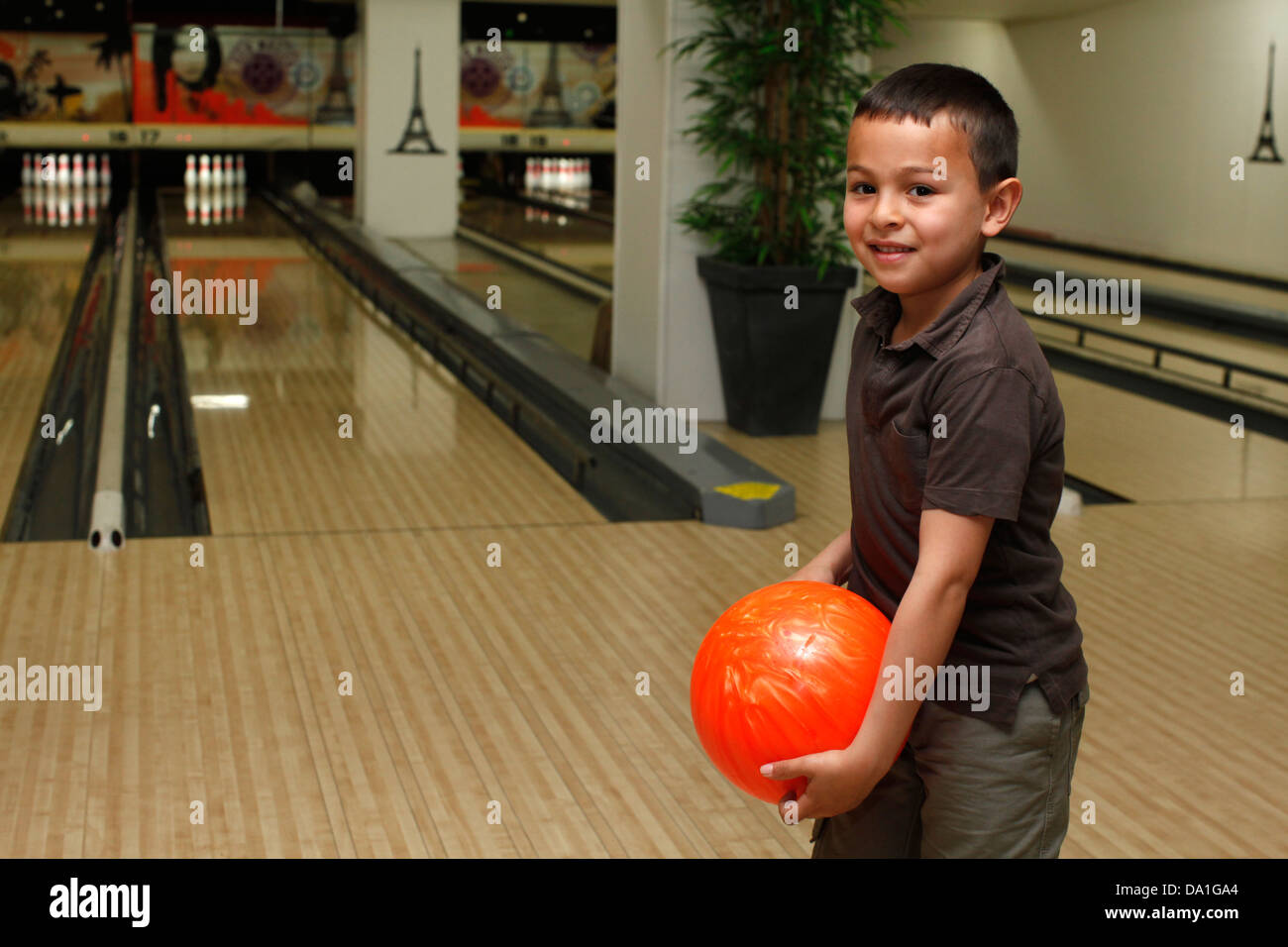 Boy playing bowling Stock Photo - Alamy