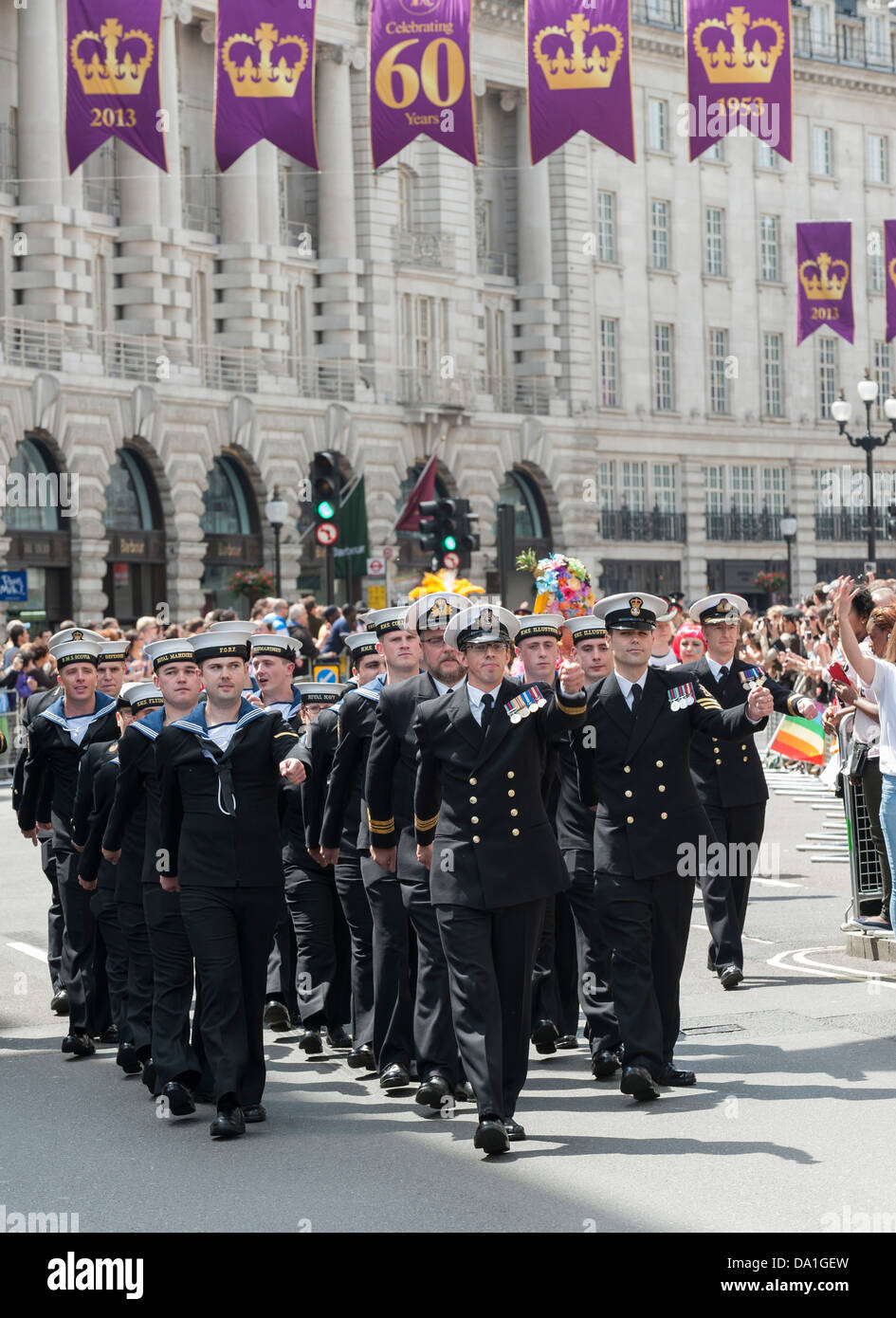 An officer leading a contingent from the Royal Navy as they march in ...