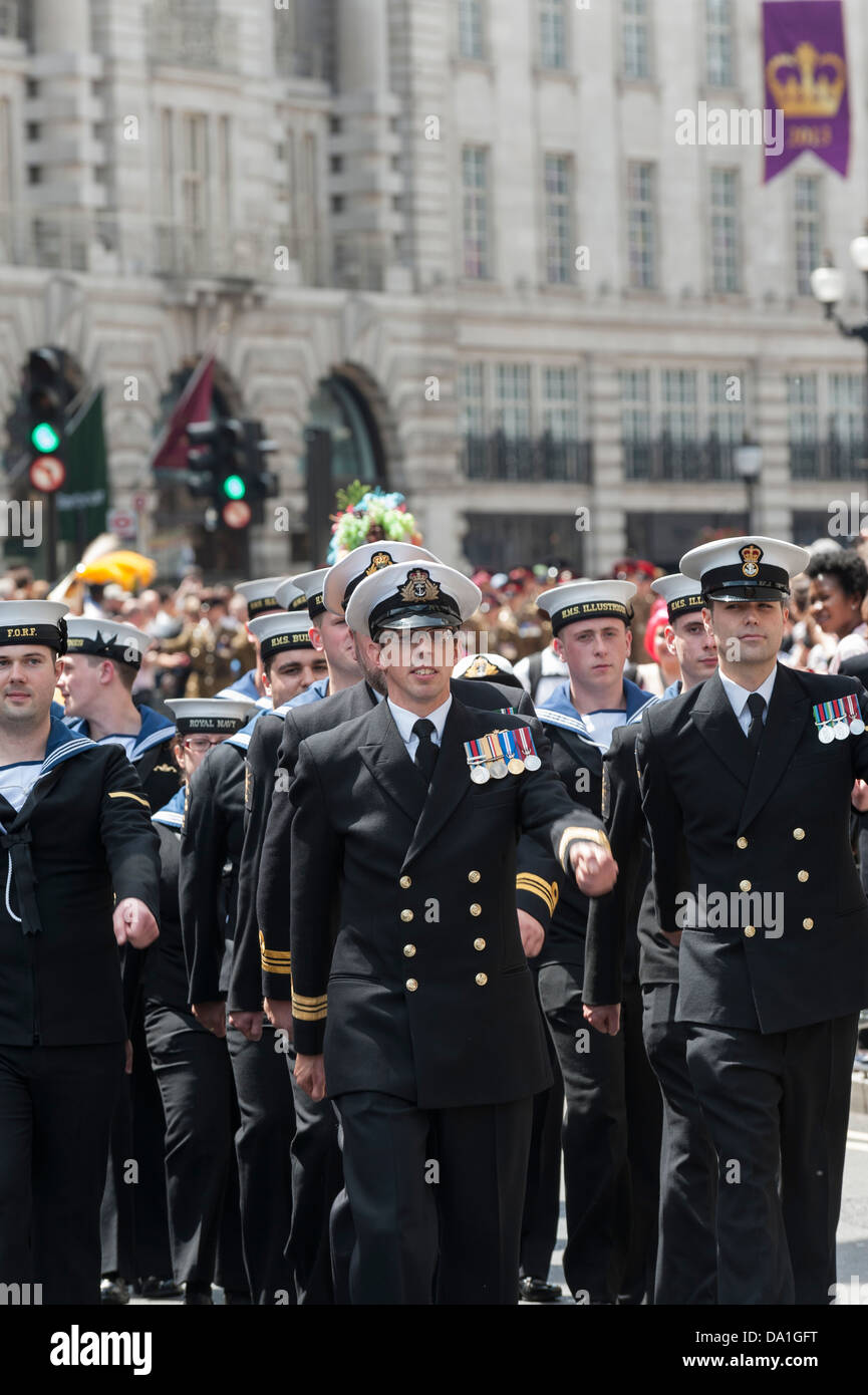 An officer leading a contingent of the Royal Naval as they march in the ...