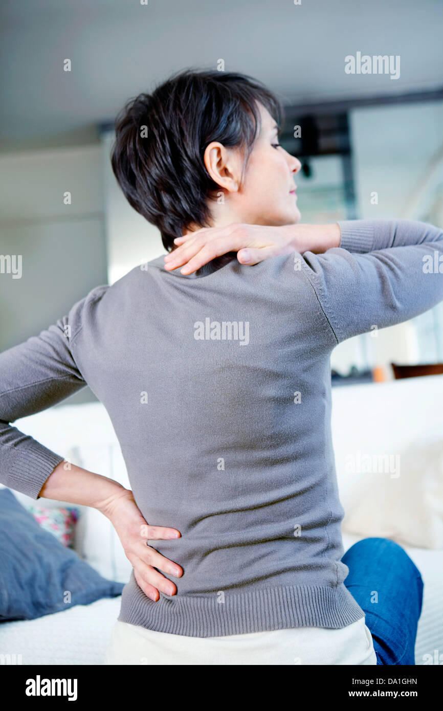 LOWER BACK PAIN IN A WOMAN Stock Photo - Alamy
