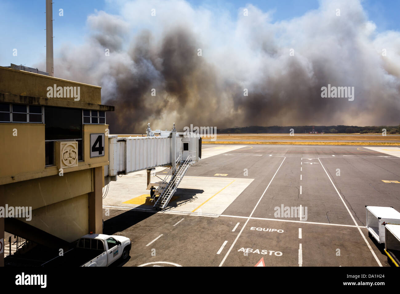 Brush fire viewed from passenger terminal San Salvador International ...