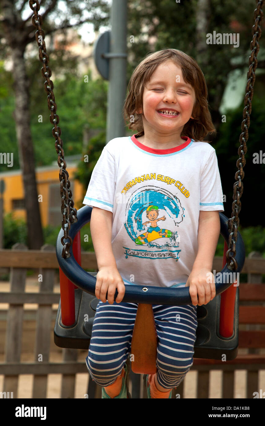 Boy on swing hi-res stock photography and images - Alamy