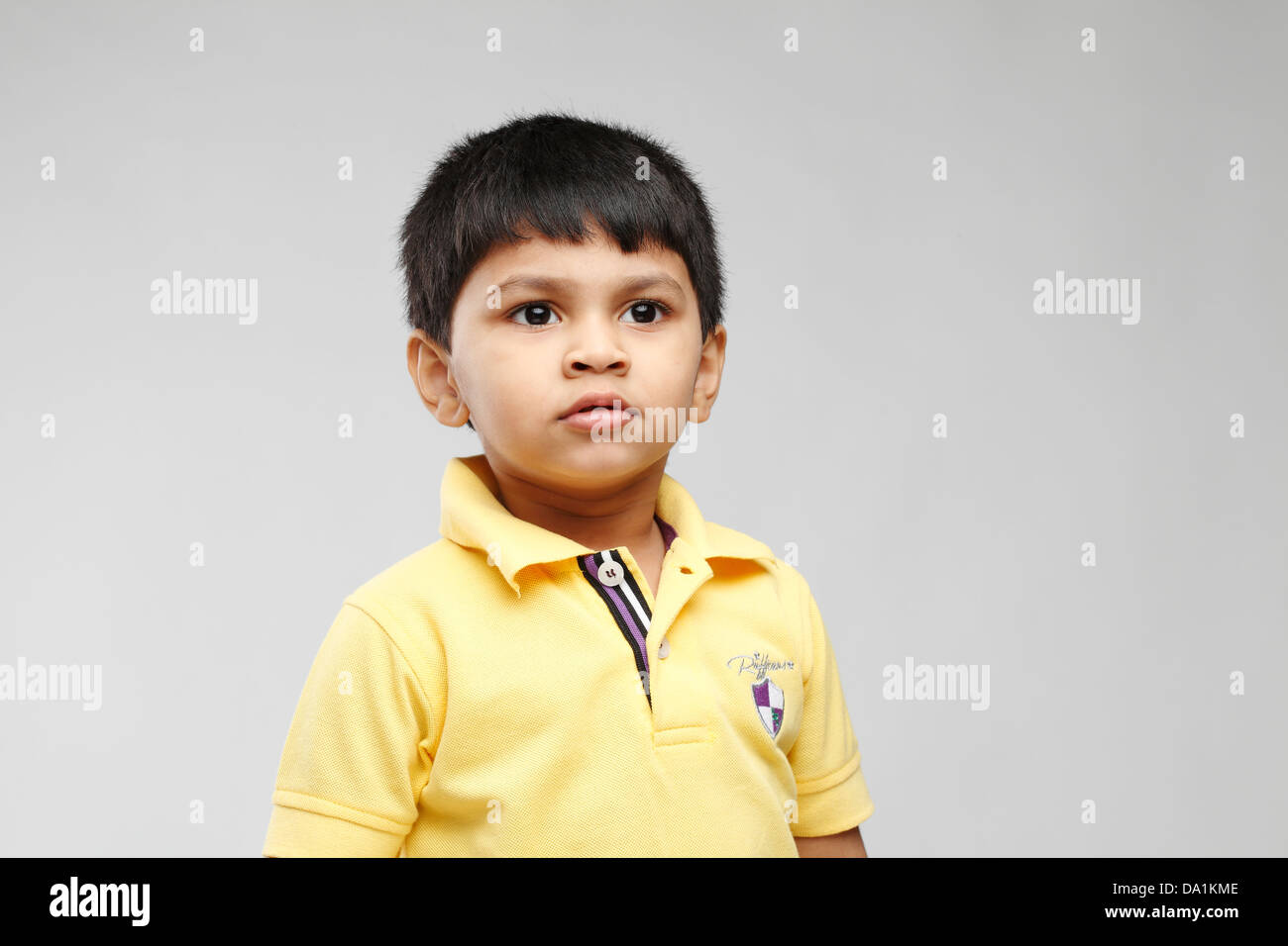 Little Indian kid is looking with curiosity Stock Photo - Alamy