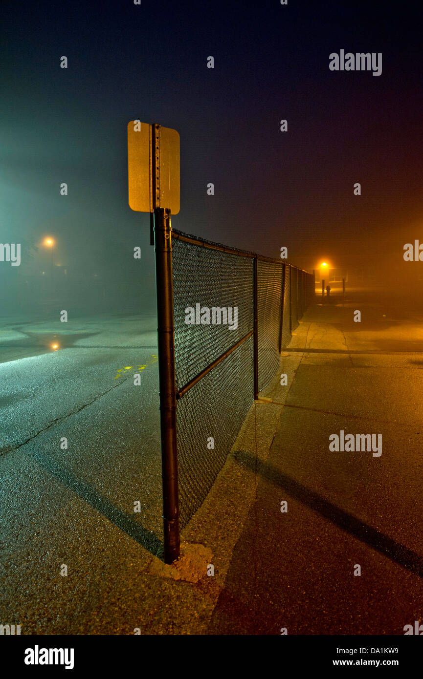Wire fence lit by street lights at night Stock Photo - Alamy