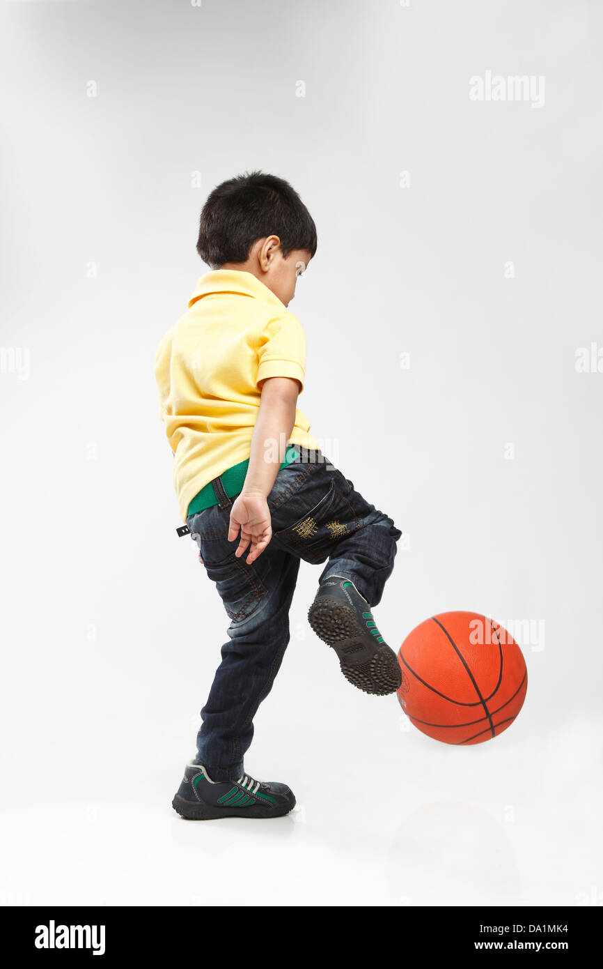Little 5 year old Indian kid kicking a ball Stock Photo - Alamy
