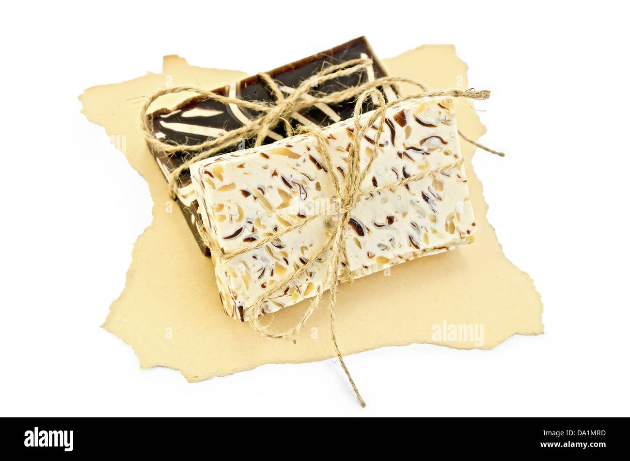 Homemade soap beige and brown on a yellow piece of old paper isolated ...