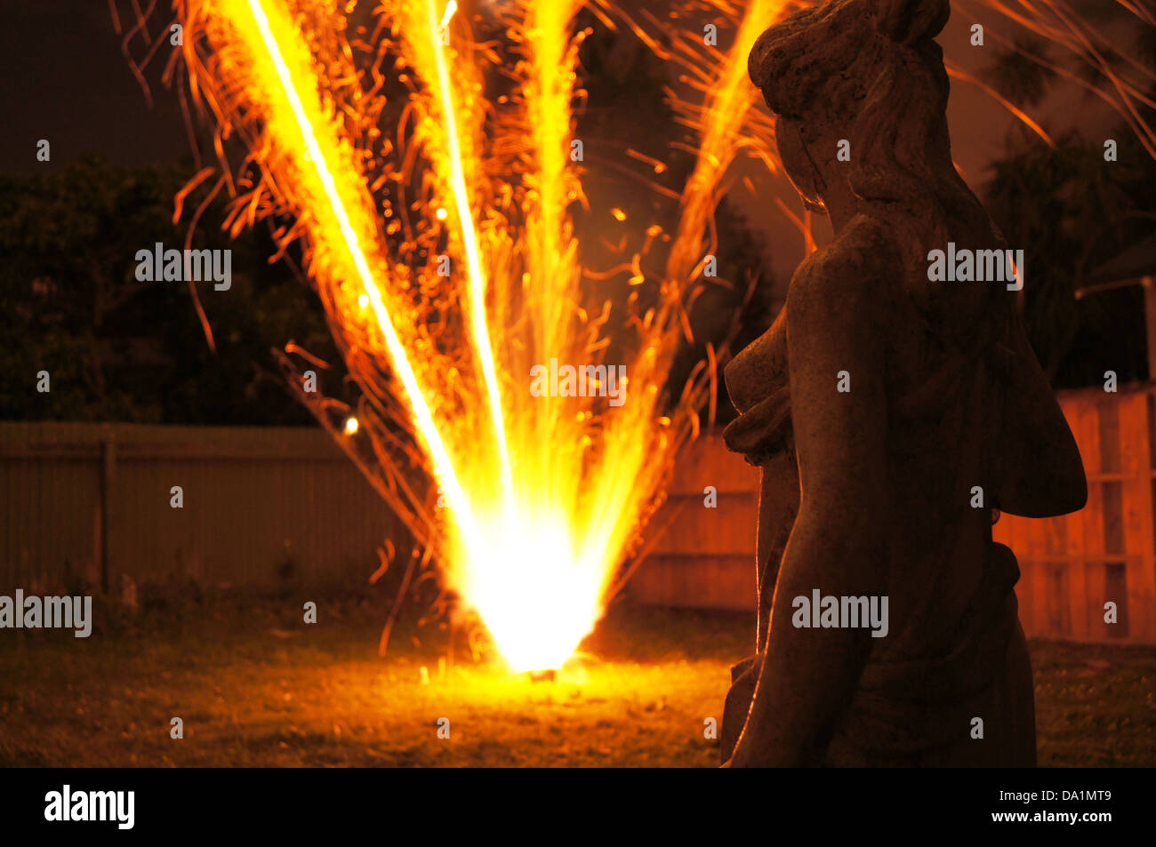 A garden statue of a lady, positioned to watch the fireworks ...