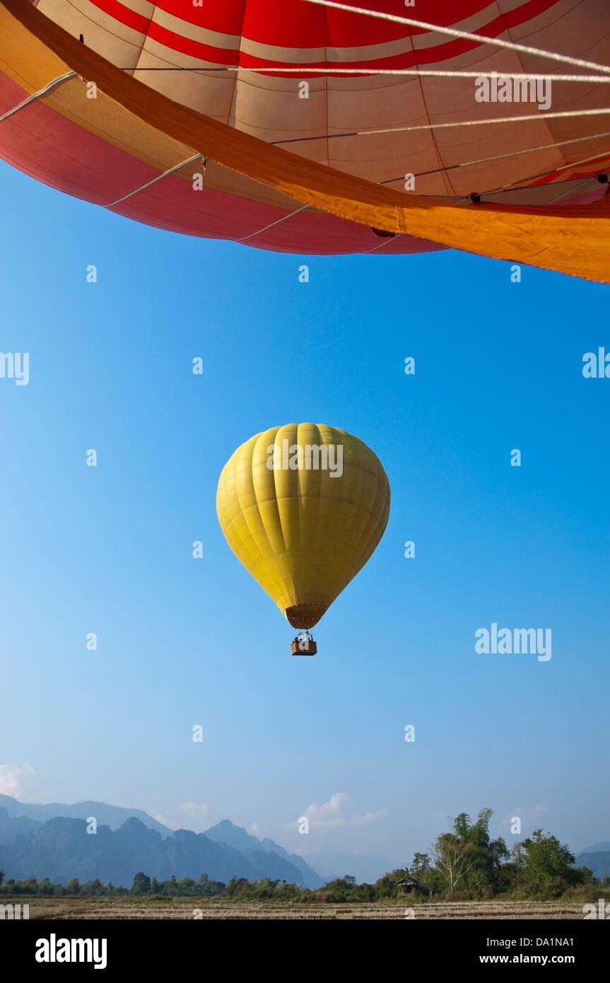 Vertical aerial view of a hot air balloon in flight and the landscape ...