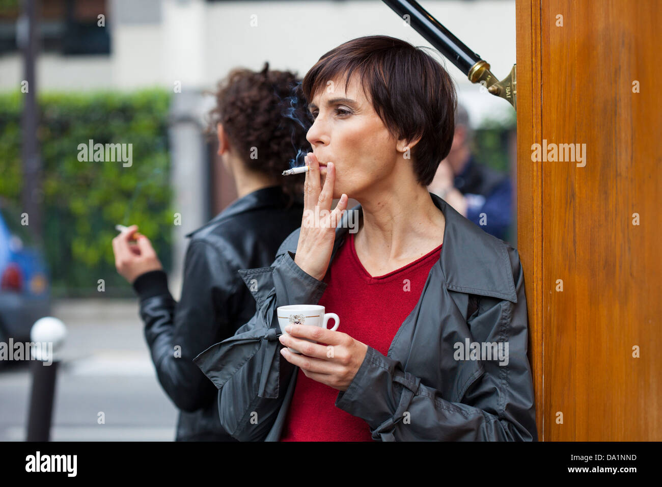 Woman smoking outside cafe hi-res stock photography and images - Alamy