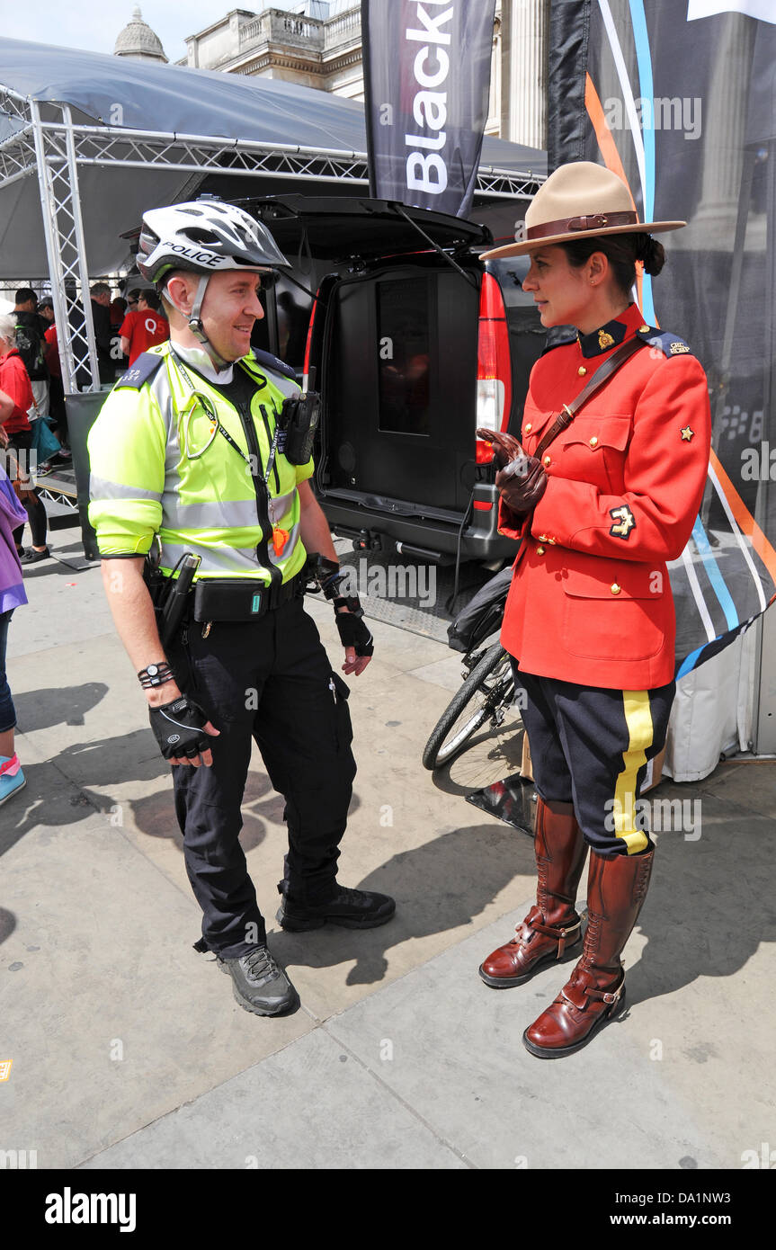 London, UK. 1st July 2013. A British police officer talks to a Royal ...