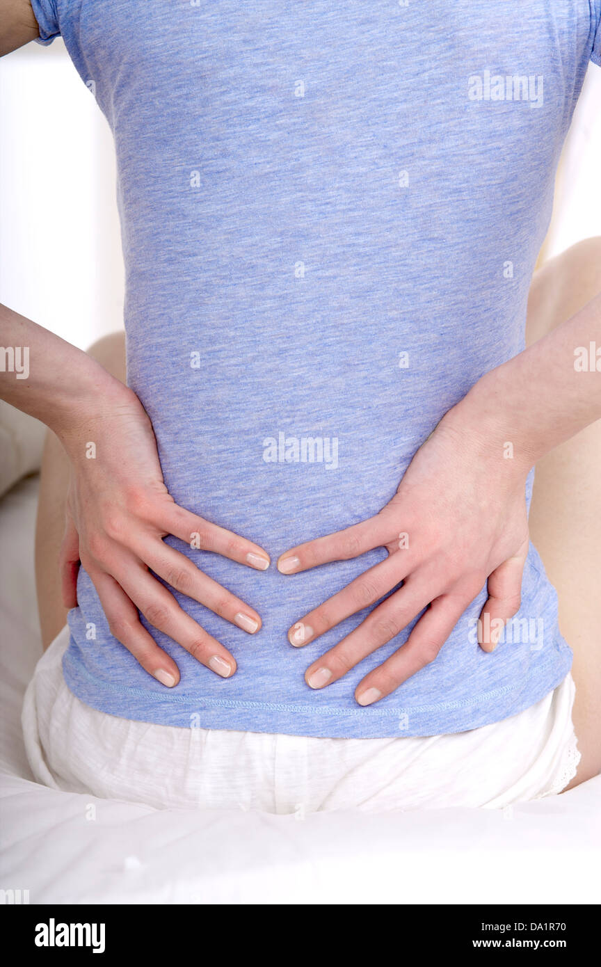LOWER BACK PAIN IN A WOMAN Stock Photo - Alamy
