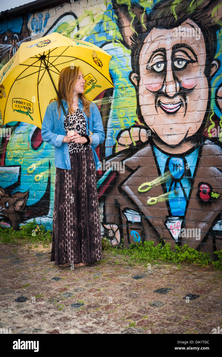 Graffiti in back alleyway and young blond female model Stock Photo - Alamy
