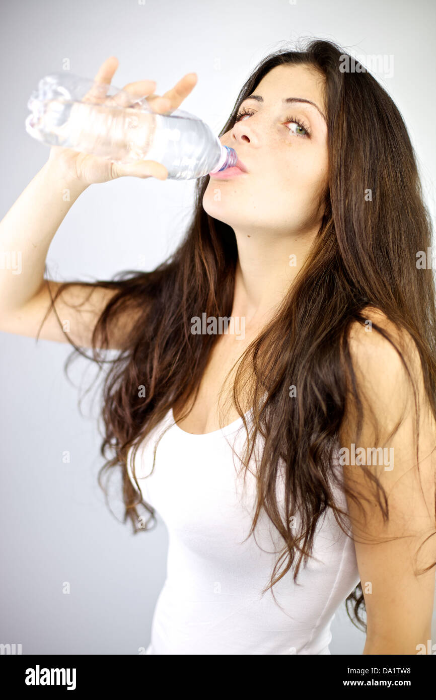 Gorgeous female model drinking water from bottle thirsty Stock Photo ...