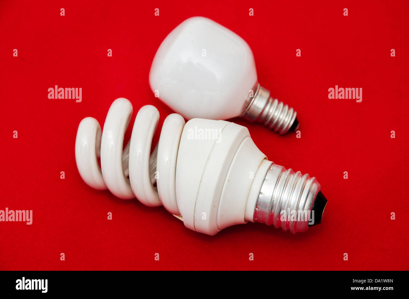White light bulb on a red background Stock Photo - Alamy
