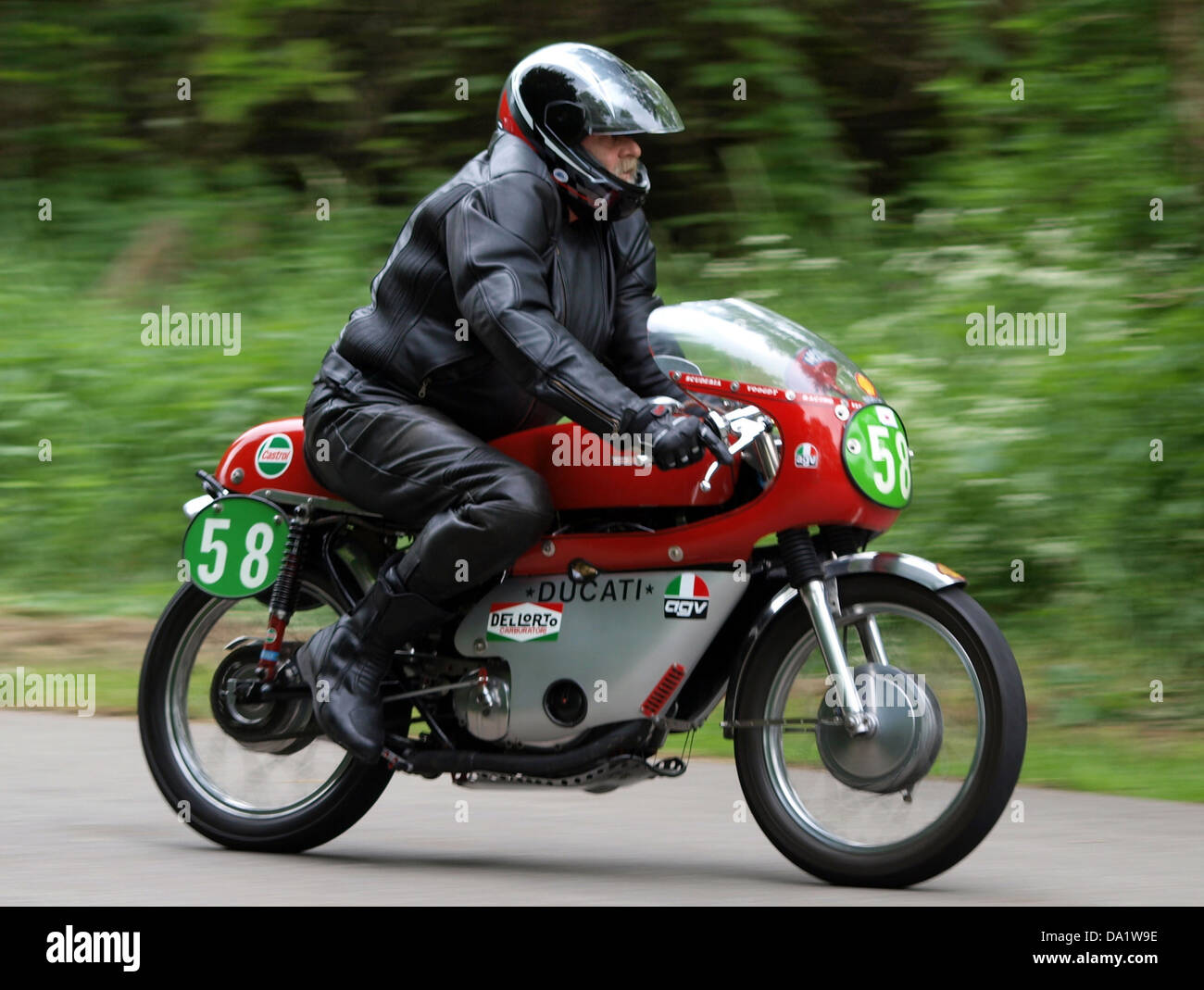 This image features a Ducati motorcycle with registration number ...