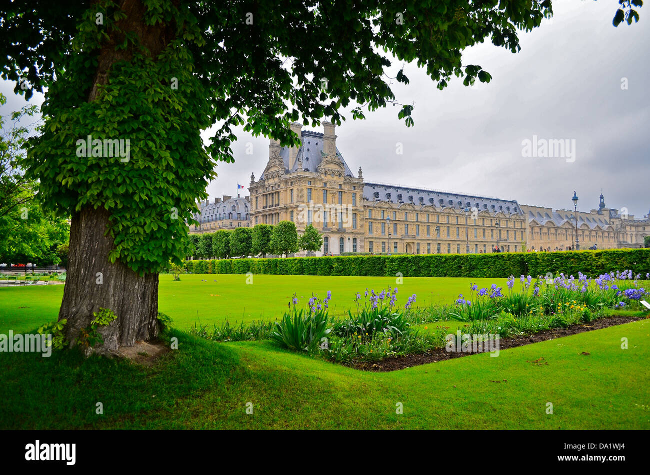 Louvre, Paris, exterior view from Tuileries gardens with cloudy sky and ...