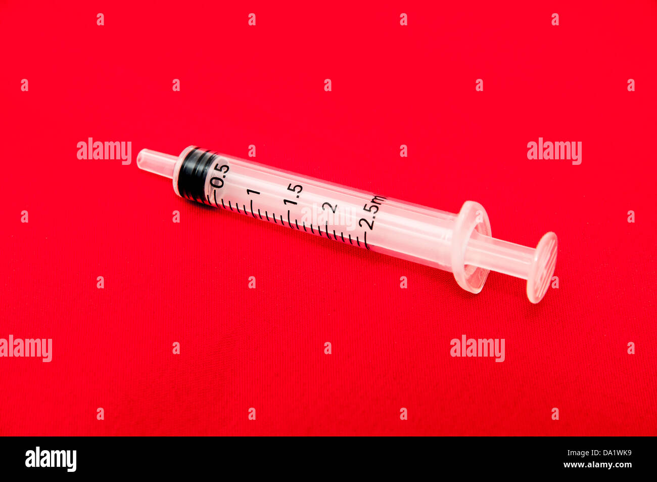 medical syringe on a red background Stock Photo - Alamy