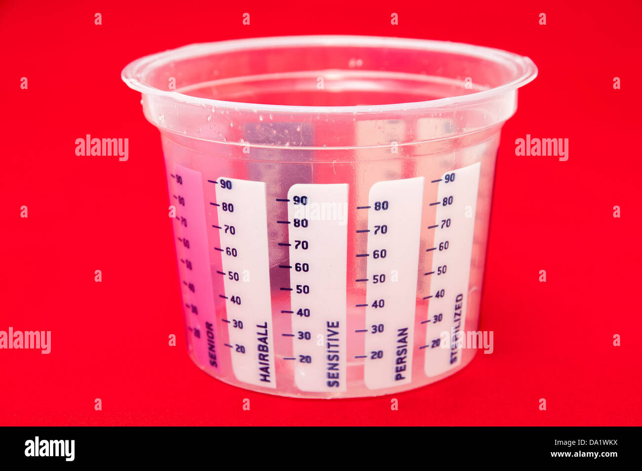 measuring cup on a red background Stock Photo - Alamy