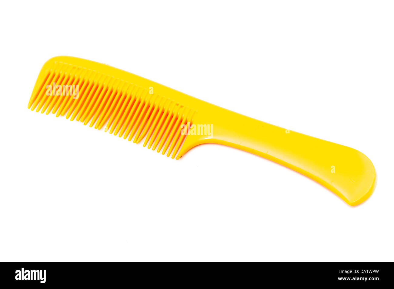 yellow comb on a white background Stock Photo - Alamy
