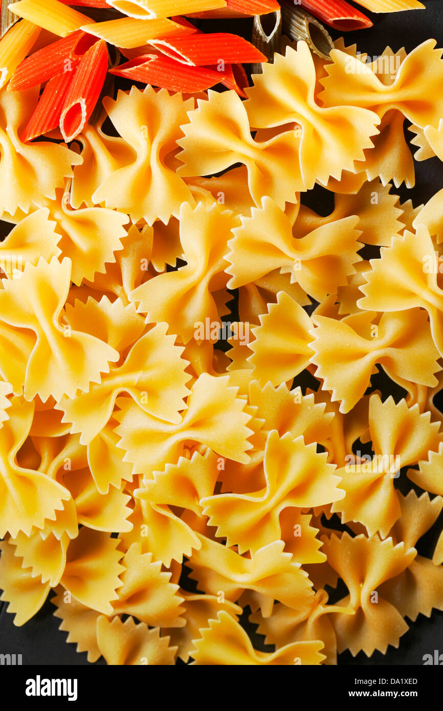 Variety of types and shapes of Italian pasta on black table Stock Photo ...
